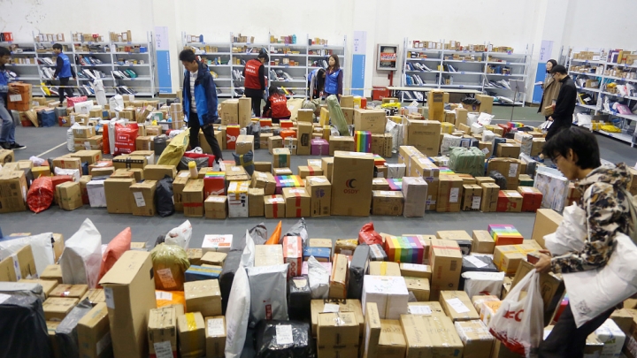 College students collect packages in the gym after the Singles' Day ...