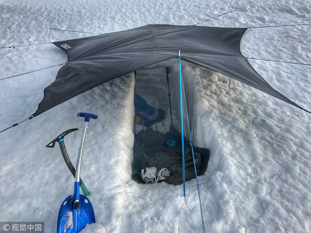 Adventurer braves freezing weather to camp in snow cave in Scotland ...